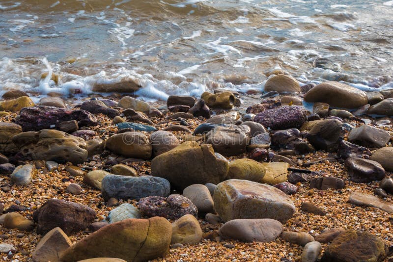 Colorful rock at beach stock photo. Image of ocean, texture - 79345360