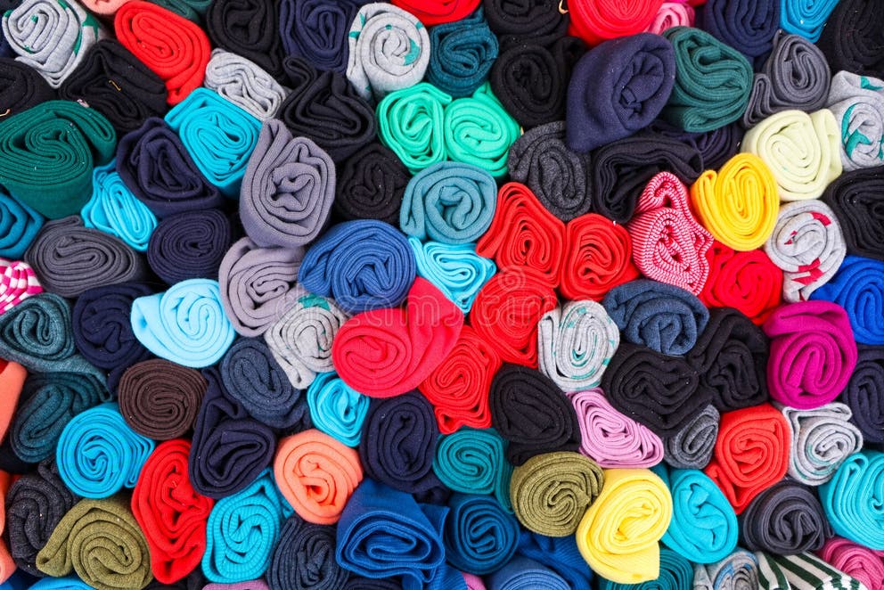 Colorful Rolled Clothes Forming a Vibrant Textile Background Stock ...