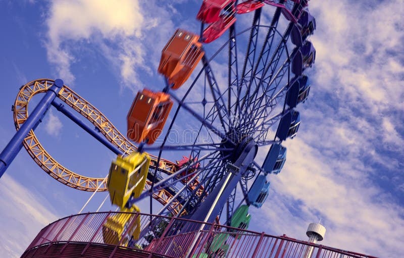 Colorful Roller Coaster and Ferris Wheel at Amusement Park Stock Photo ...