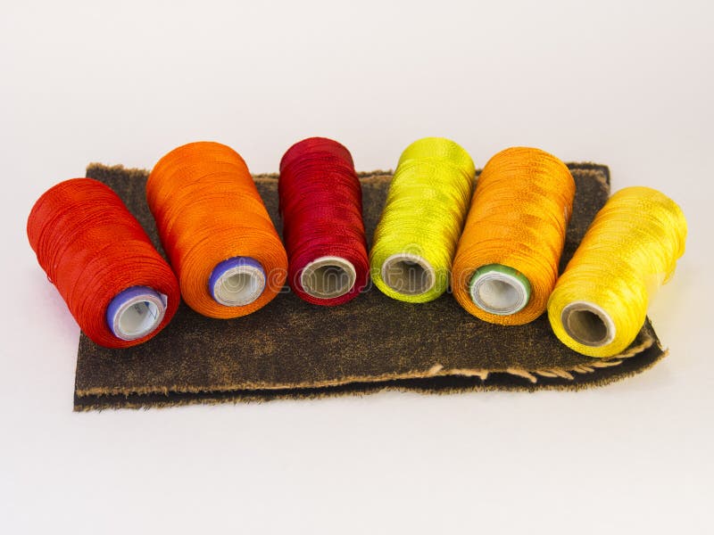 Colorful Rolls of Thread on a Piece of Leather. Stock Photo - Image of ...