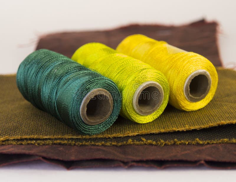 Colorful Rolls of Thread on a Piece of Leather. Stock Photo - Image of ...