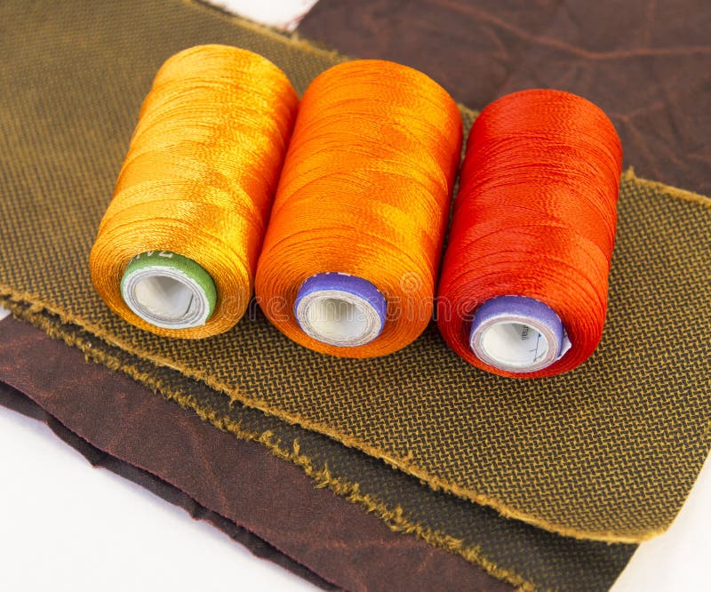 Colorful Rolls of Thread on a Piece of Leather. Stock Photo - Image of ...