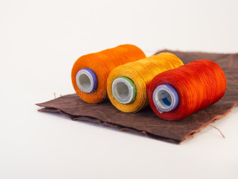 Colorful Rolls of Thread on a Piece of Leather. Stock Image - Image of ...