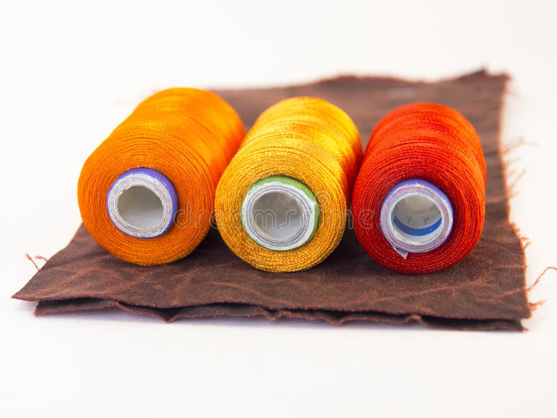 Colorful Rolls of Thread on a Piece of Leather. Stock Image - Image of ...