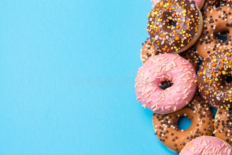 Colorful Round Donuts on Blue Background. Flat Lay, Top View Stock ...