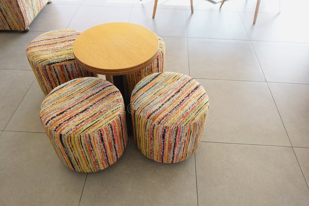 Colorful Round Stools and Table in Modern Interior Setting Stock Photo ...