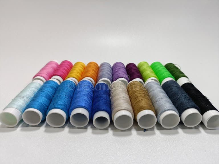 Colorful Sewing Thread Spools Arranged in Rows on White Background ...