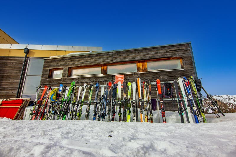 Colorful Skis Resting Outside Mountain Lodge Stock Photo - Image of ...