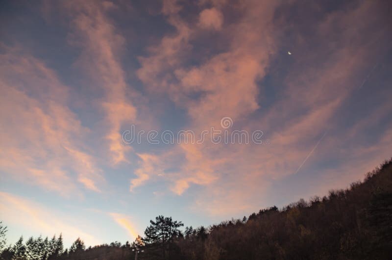 Colorful sky at dawn stock image. Image of trees, mountain - 136148953
