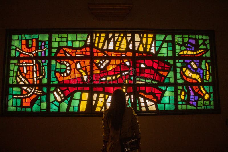 Colorful Stained Glass Window with Woman Standing in Front Editorial ...