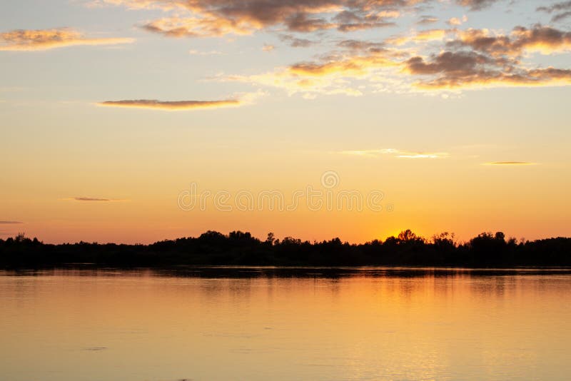 A Colorful Sunny Sunset is Reflected on the Surface of the Calm Lake ...