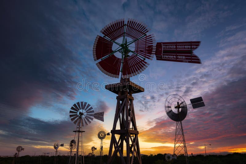 Dramatic Sunrise Over Windmills Stock Photo - Image of restored ...