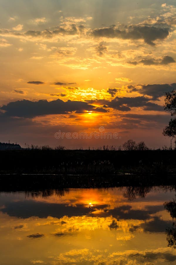 Colorful Sunset Behind the Clouds Above the Water Stock Image - Image ...