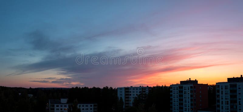 Colorful Sunset Clouds at Dusk Over City Buildings Stock Image - Image ...
