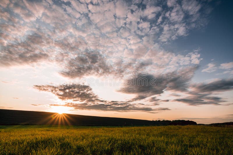 Colorful Sunset in the Fields. Sun is Going Down To the Hill Stock ...