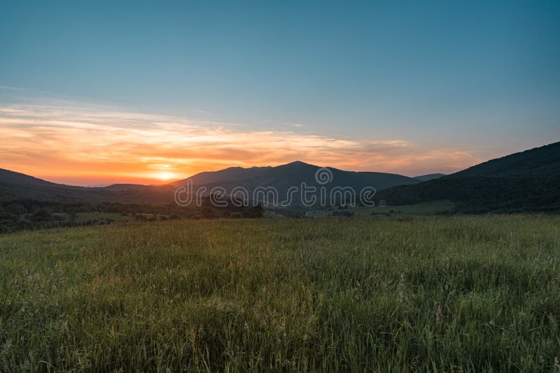 Colorful Sunset Over Grass Field in Bieszczady Mountains, Poland Stock ...