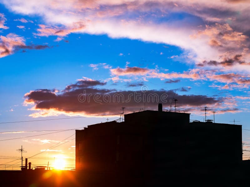 Colorful Sunset Over the High-Rise Building Silhouette with Sun Rays ...