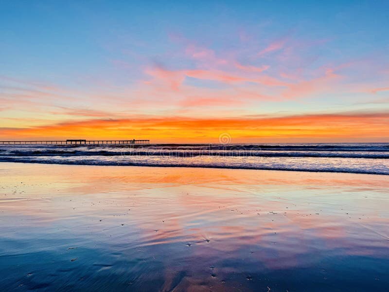 Sunset Spectrum Vibrant Hues Over Ocean Beach Pier Silhouette And