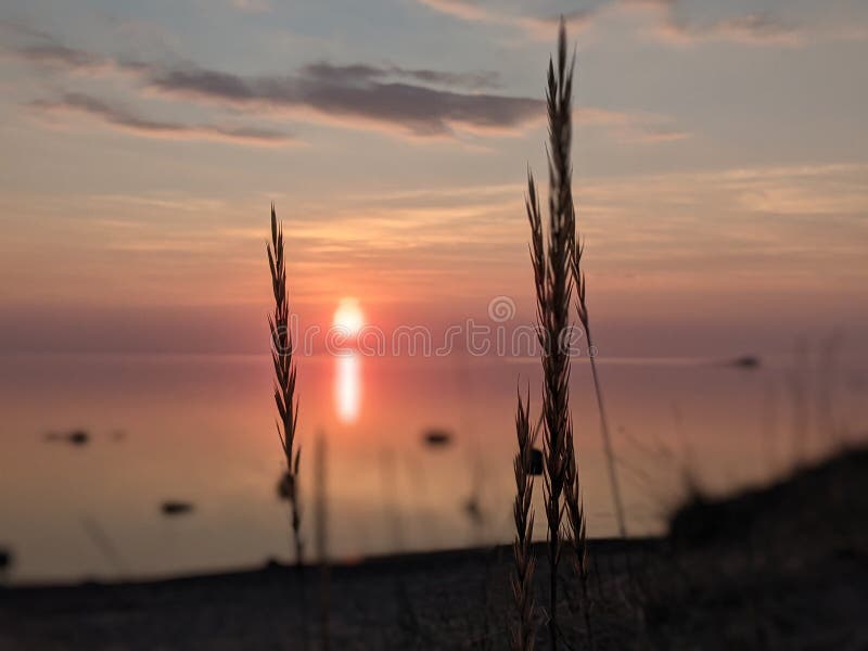Colorful Sunset on a Still Lake with Haystacks in the Foreground Stock ...