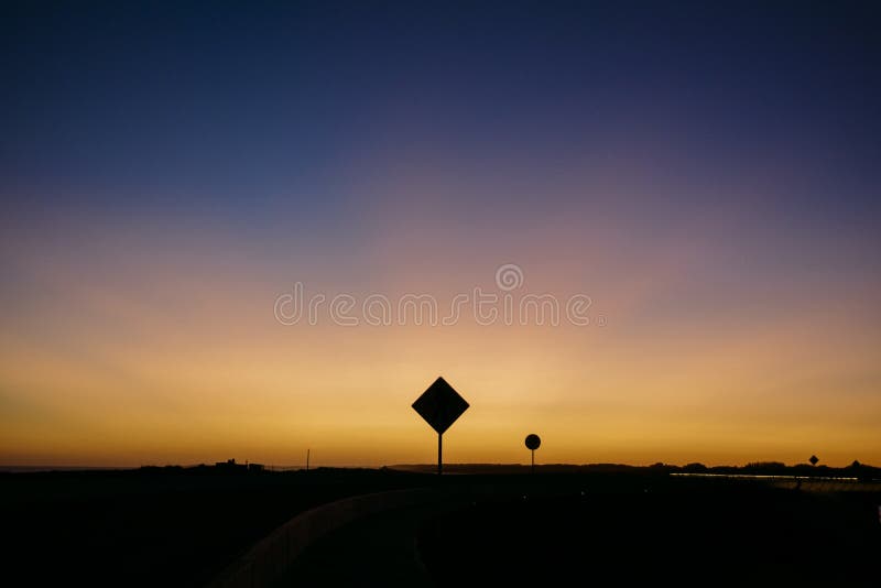 Colorful Sunset with Traffic Signs Stock Image - Image of curve ...