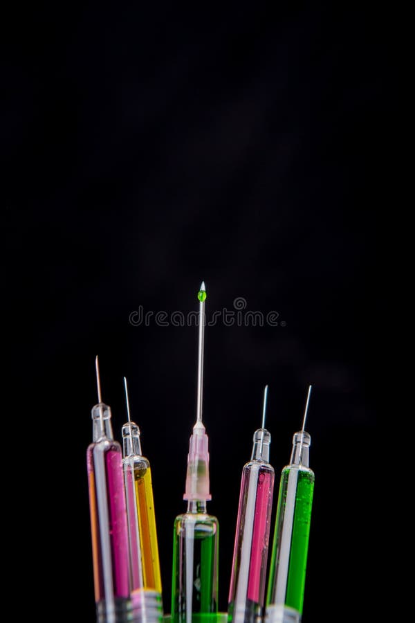 Colorful Syringe on Dark Background Stock Photo - Image of science ...