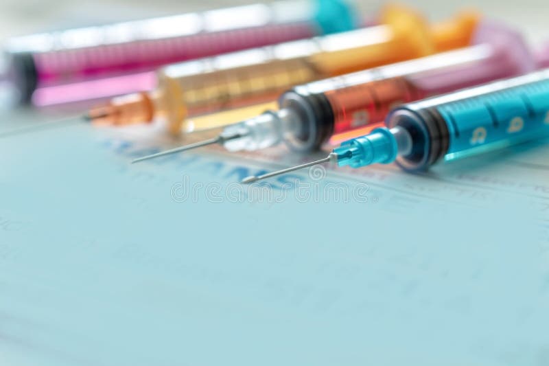Colorful Syringes with Various Liquid Medications Placed on a Medical ...