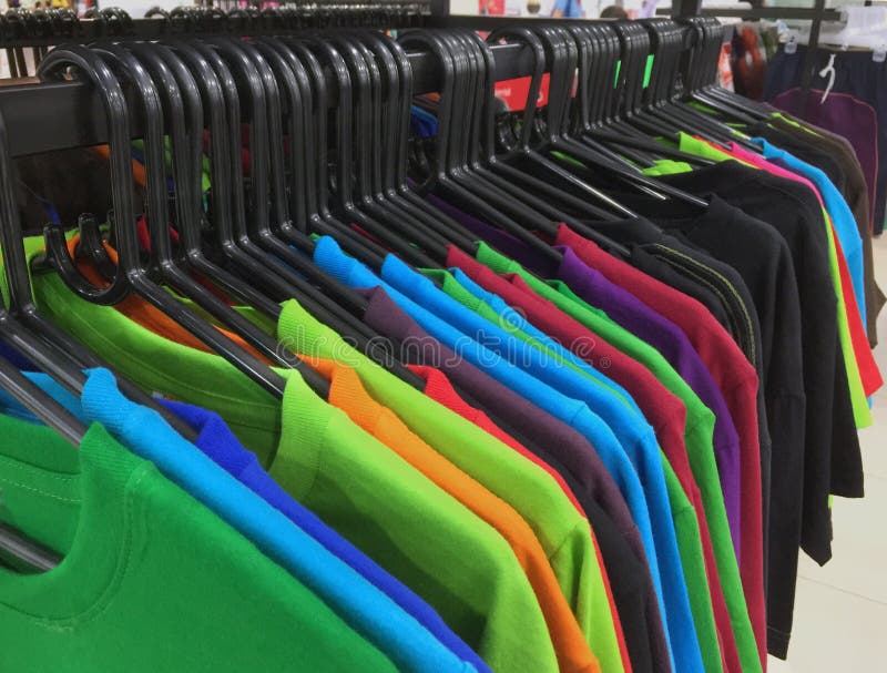 Colorful T-Shirts Hanging on a Rack Stock Photo - Image of closet ...