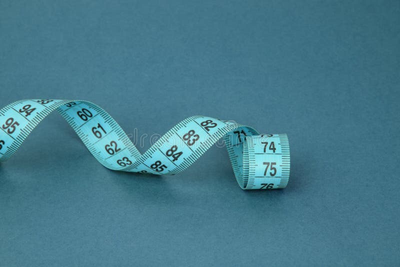 Colorful Tape Measure Spiral with Copyspace Blue Background Stock Image ...
