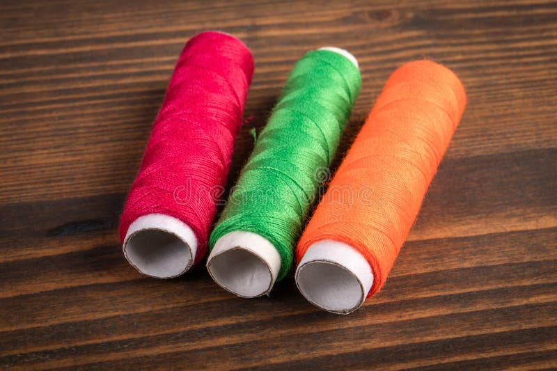 Colorful Threads in Spools on a Wooden Texture Background Stock Image ...