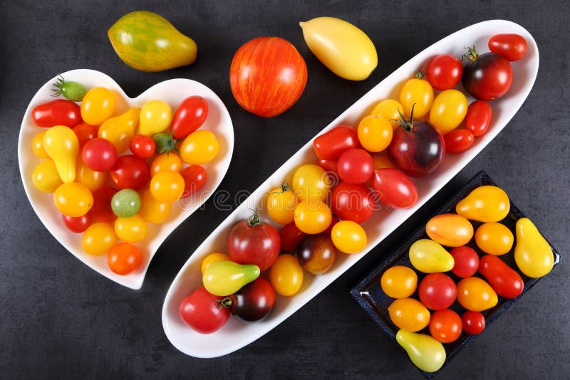 Colorful tomatoes stock photo. Image of yellow, ripe - 232097564