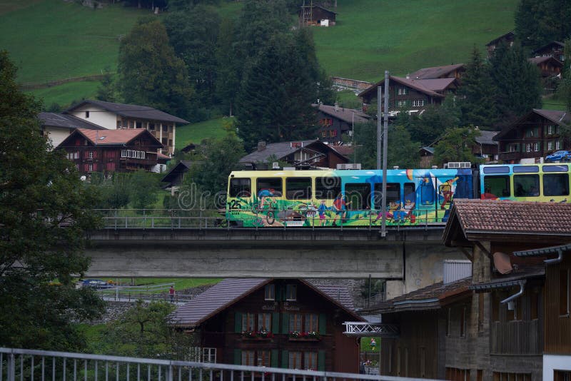 Colorful Train Around the Nature and Buildings of Switzerland Editorial ...