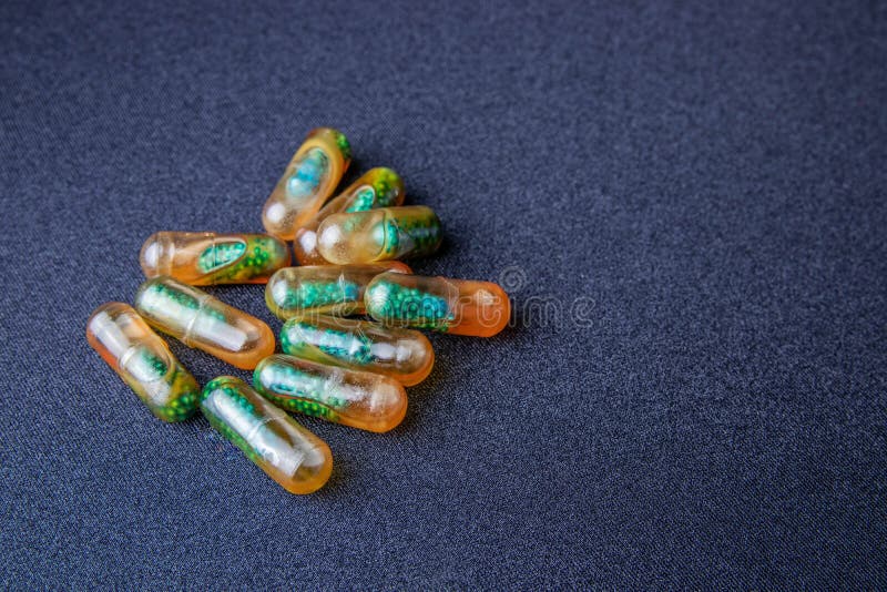 Colorful Transparent Capsules on a Dark Blue Background Stock Photo ...