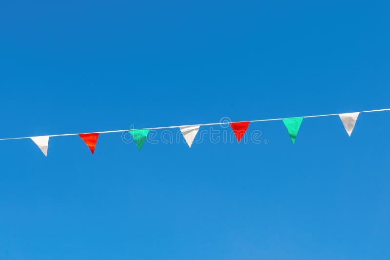 Colorful Triangular Flags Hanging Against Blue Sky. Colors of the ...