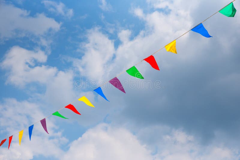 Colorful Triangular Flags on a Line , Against Cloudy Sky, Vertical ...