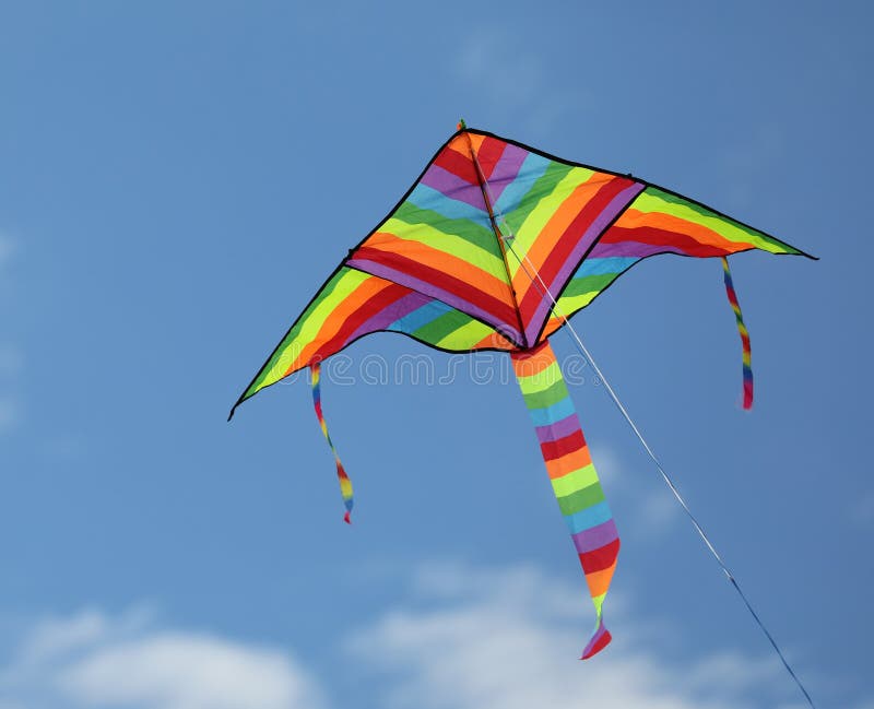 Colorful Triangular Kite Flying High in the Blue Sky with Some W Stock ...