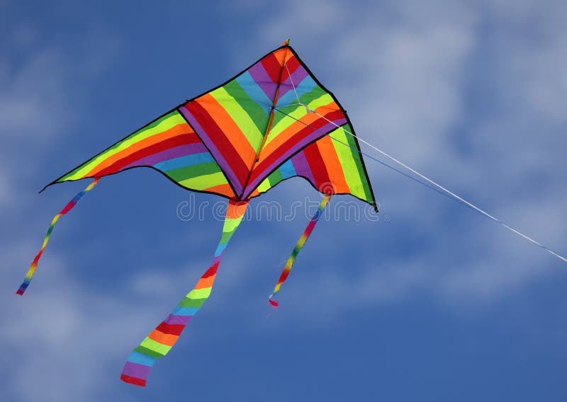 Colorful Triangular Kite Flying High in the Blue Sky with Some W Stock ...