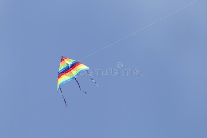 A Colorful Triangular Kite Flying in the Sky Stock Photo - Image of ...