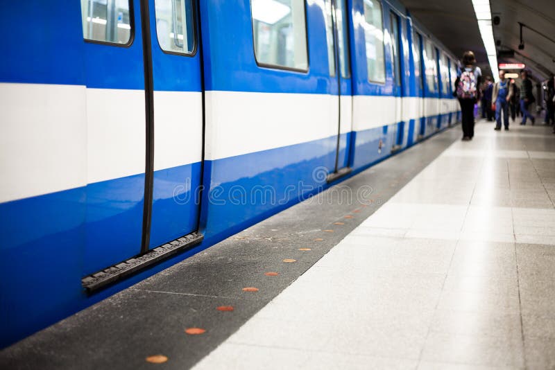 Colorful Underground Subway Train with Blurry People in the Back Stock ...