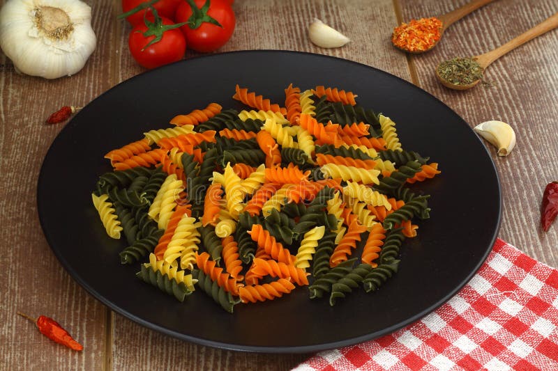 Colorful Various Raw Fusilli on Black Plate Stock Photo - Image of ...