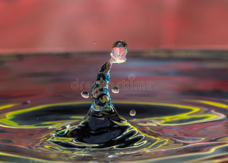 Colorful water drop impact stock image. Image of backgrounds - 140876451