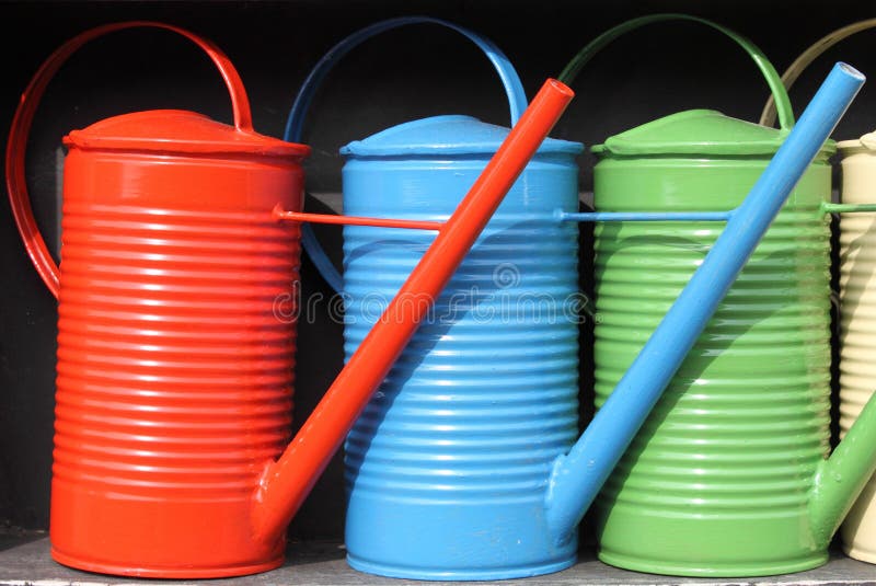 Colorful watering cans stock photo. Image of green, cans - 142597088