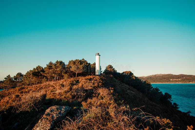 Colorful White and Blue Lighthouse in the Coast of Spain Stock Image ...