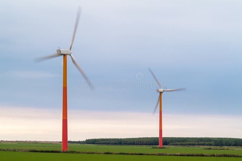 Colorful Wind Turbines on a Green Meadow Stock Image - Image of meadow ...