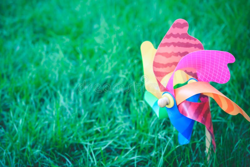 Colorful Wind Wheels on Green Grass with Blank Space Stock Photo ...