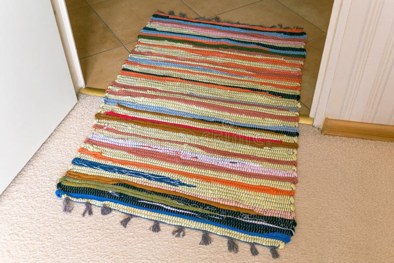 Colorful Woven Doorway Rug on Carpet and Tile Transition Stock Image ...