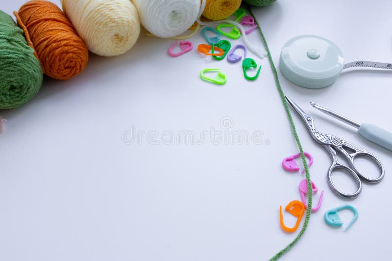 Colorful Yarn Balls with Crochet Tools and Stitch Markers on White ...