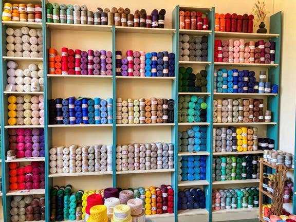 Colorful Yarn Store, Blue and White Shelved, Array of Rainbow-colored ...