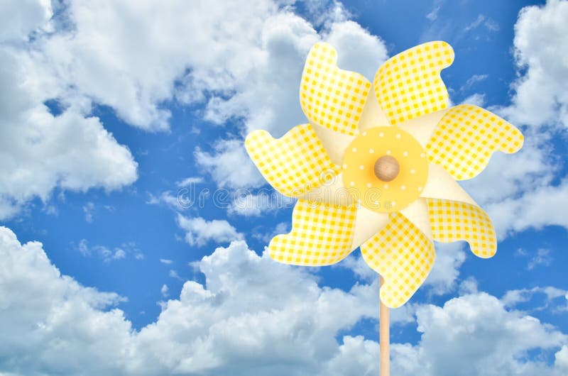 Colorful Yellow Pinwheel Over Blue Sky with Clouds Stock Photo - Image ...