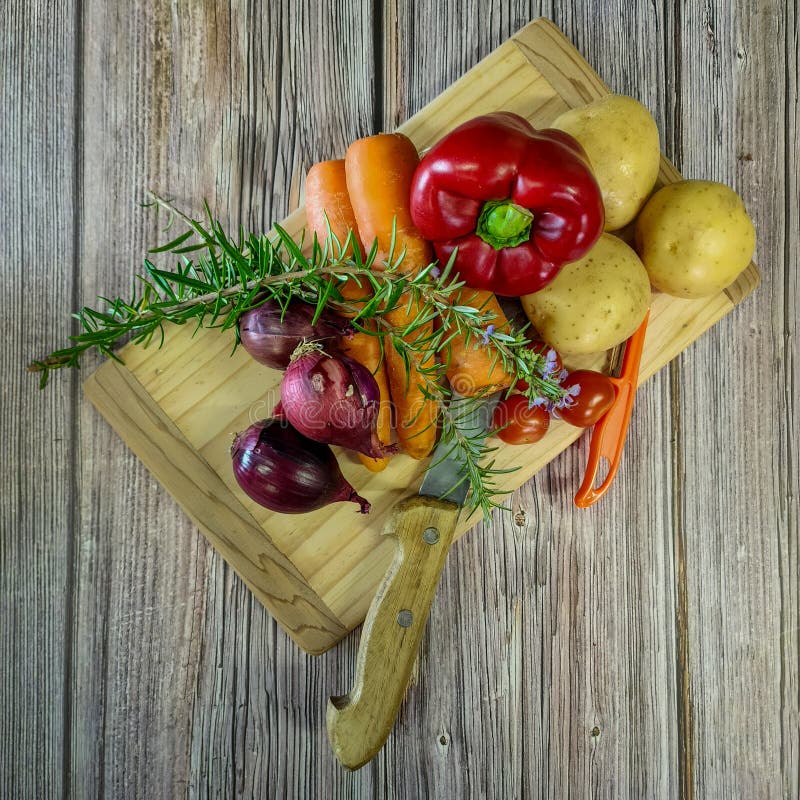 Colour Fresh Vegetables on Cutting Board on Rustic Table Stock Photo ...
