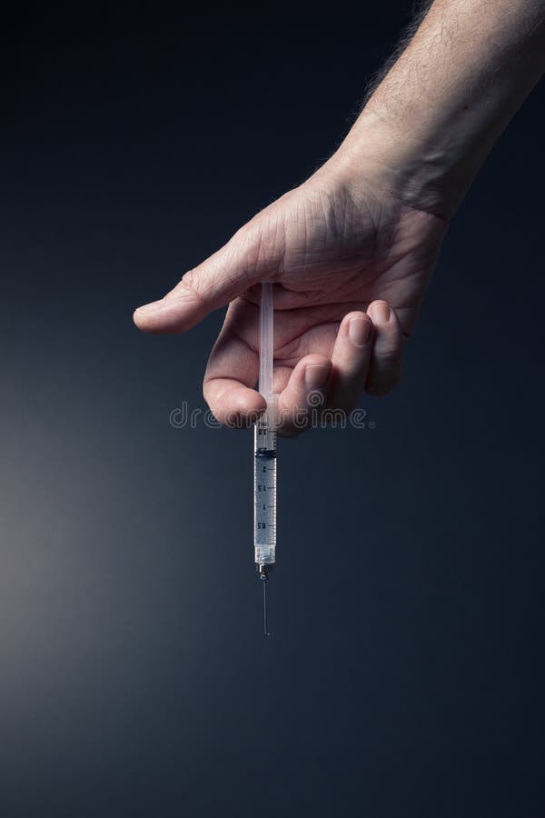 Man`s Hand Holding Syringe with Dramatic Lighting Stock Photo - Image ...